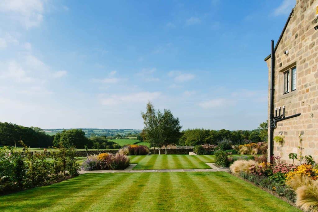 Contemporary country garden with all weather outdoor sofas
